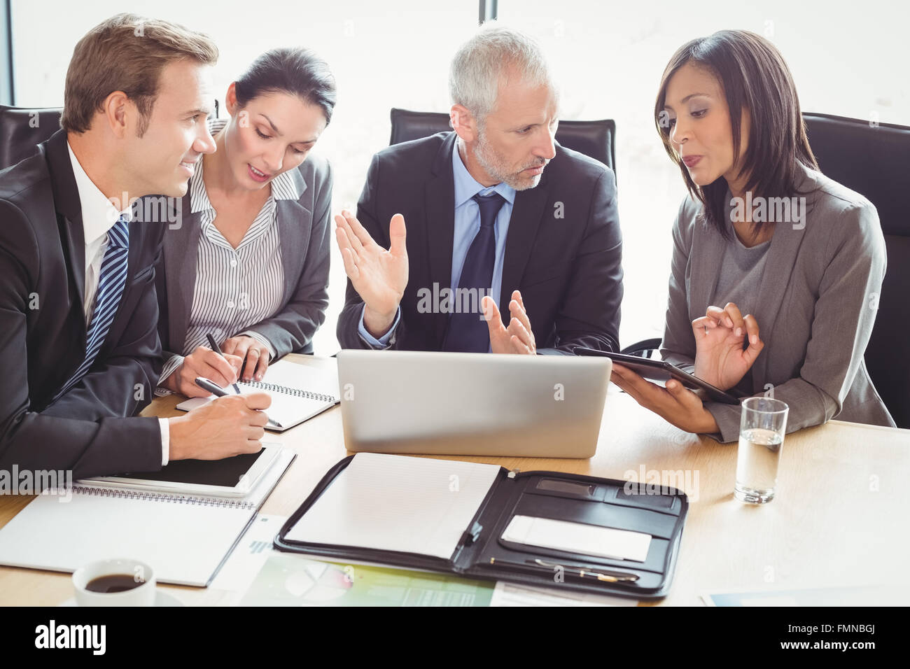 Businesspeople interacting in conference room Stock Photo - Alamy