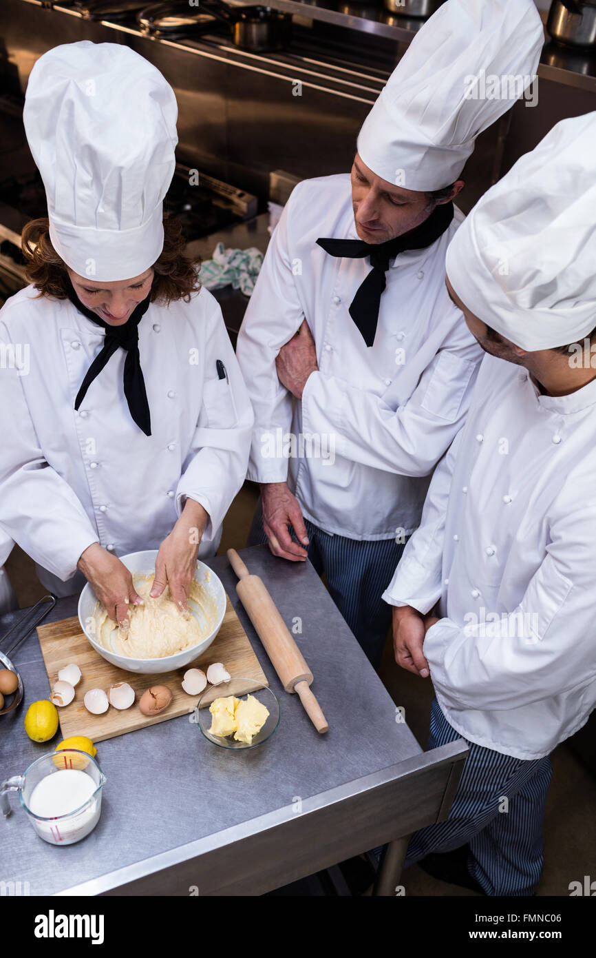 Head chef teaching his team to prepare a dough Stock Photo - Alamy