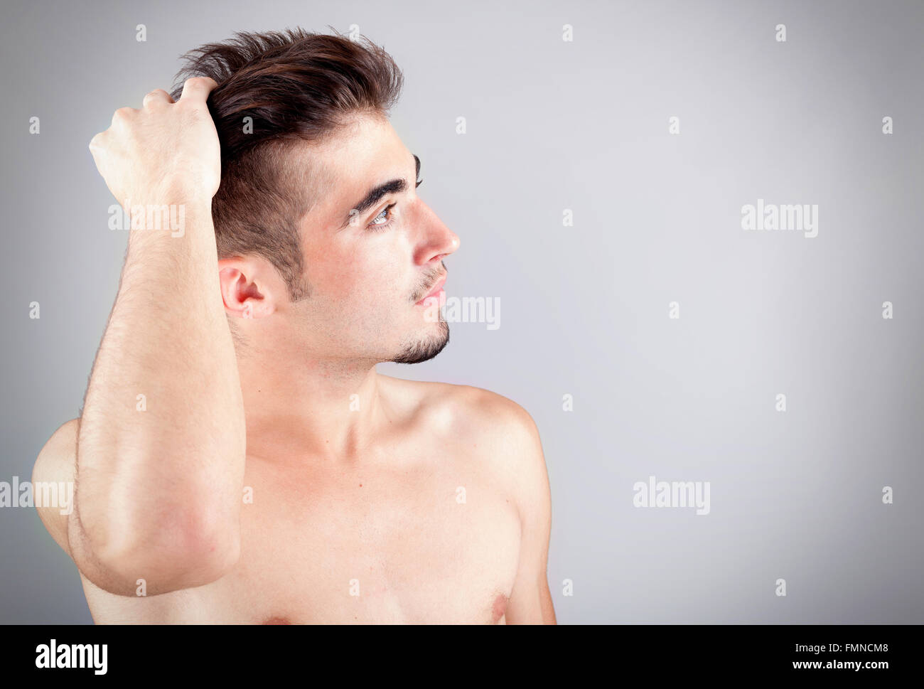 Portrait of a handsome young man, over a grey background Stock Photo ...