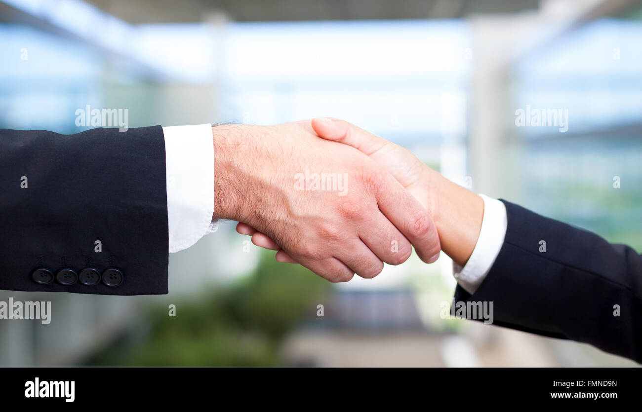 Teamwork shaking hands at the office Stock Photo - Alamy