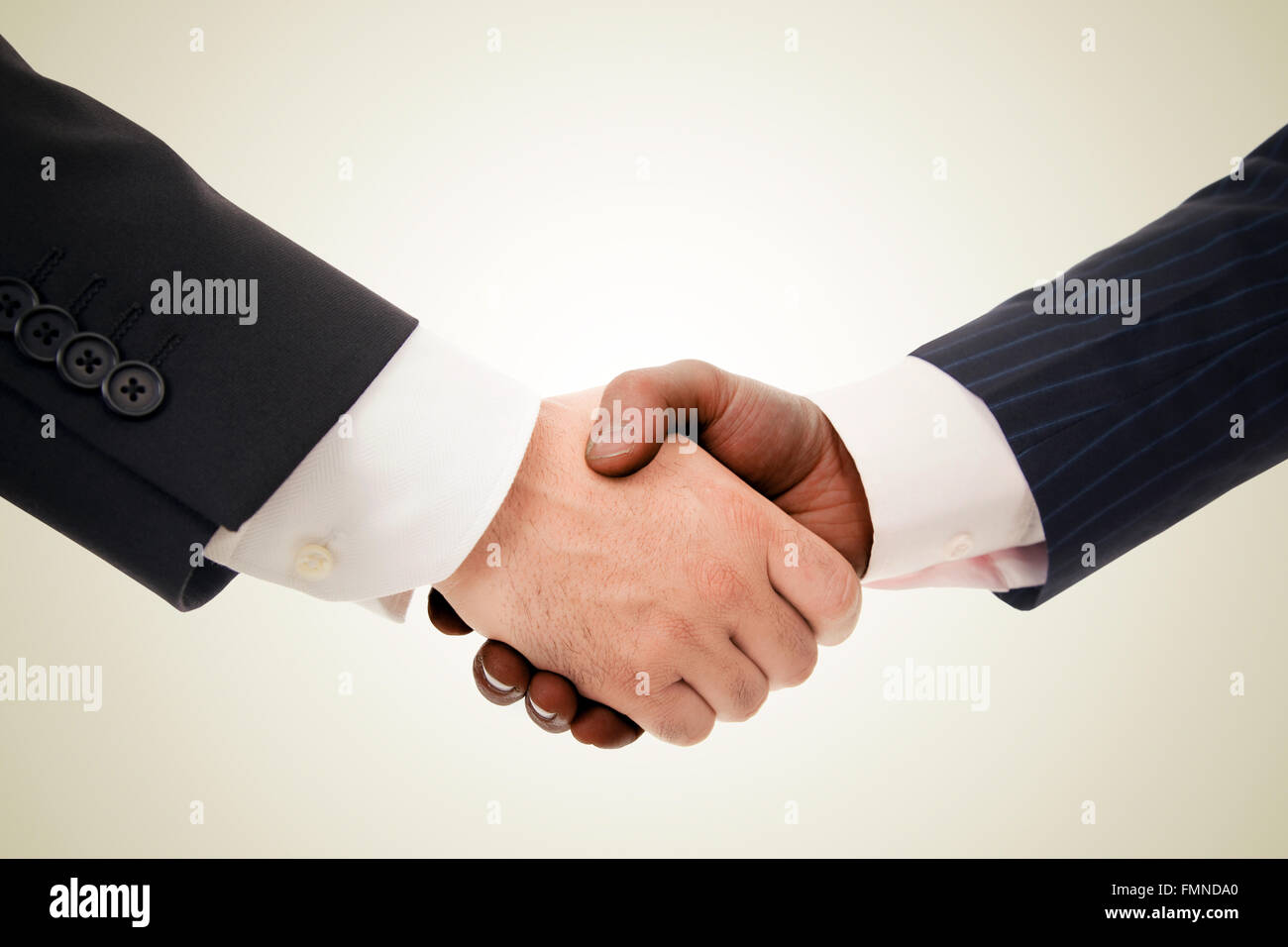 Closeup of a multiracial handshake between two business men Stock Photo ...