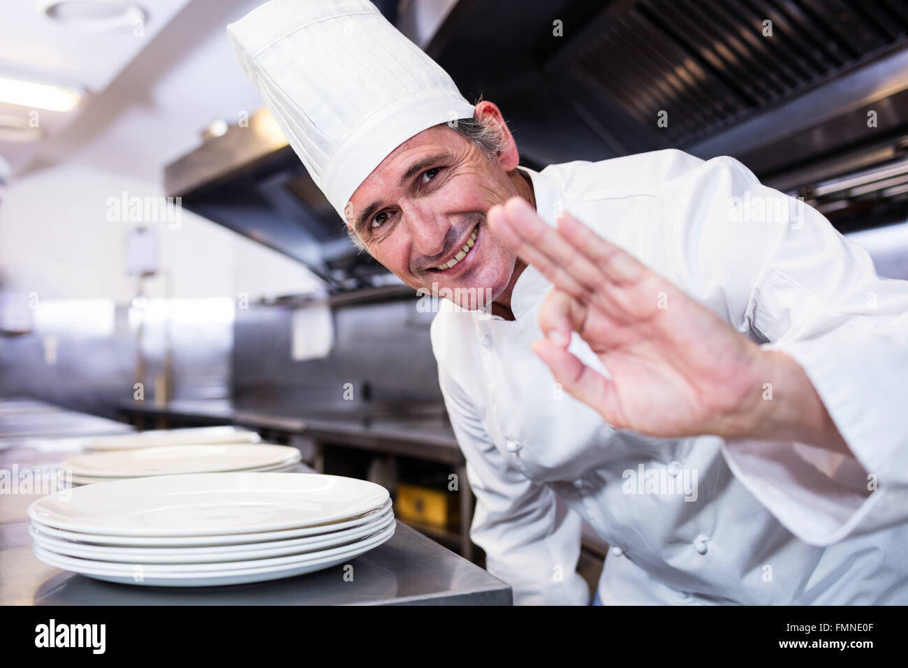 Smiling chef showing ok sign Stock Photo - Alamy