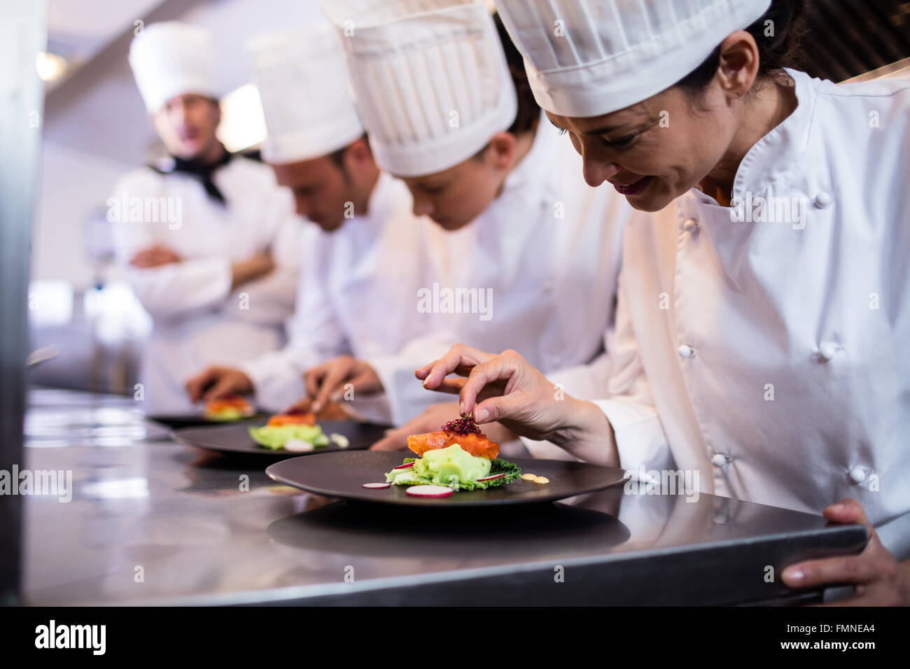 Chef decorating a food plate Stock Photo - Alamy
