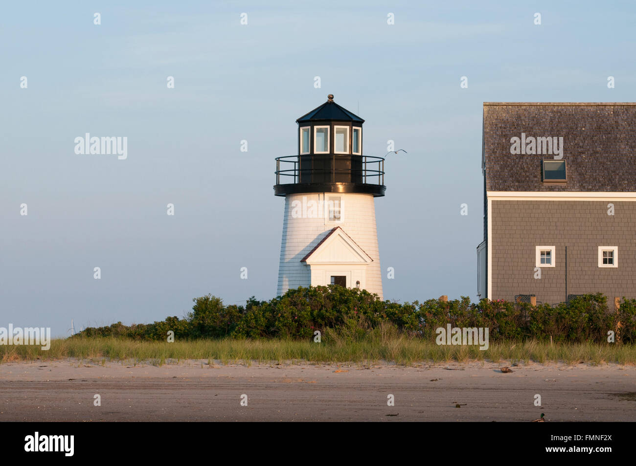 Hyannis Harbor lighthouse tower as the sun sets on a warm summer day ...