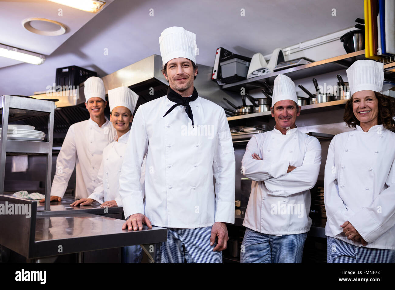 Happy chefs team standing together in commercial kitchen Stock Photo ...