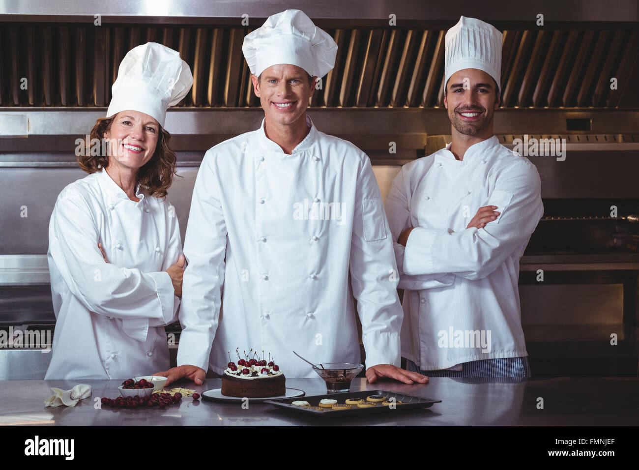 Chefs happy and proud to present the cake they just made Stock Photo ...