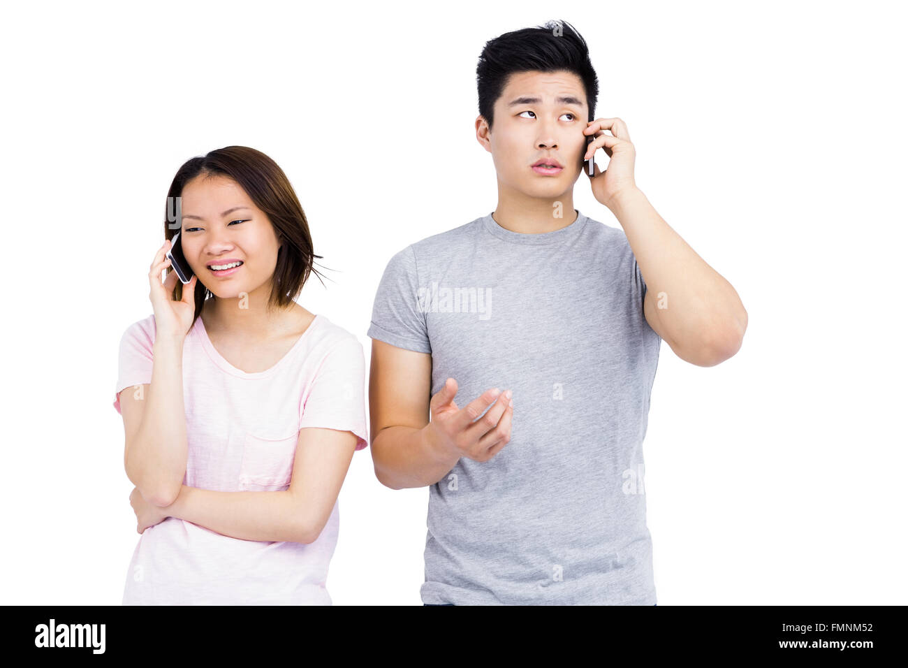 Young couple talking on mobile phone Stock Photo - Alamy