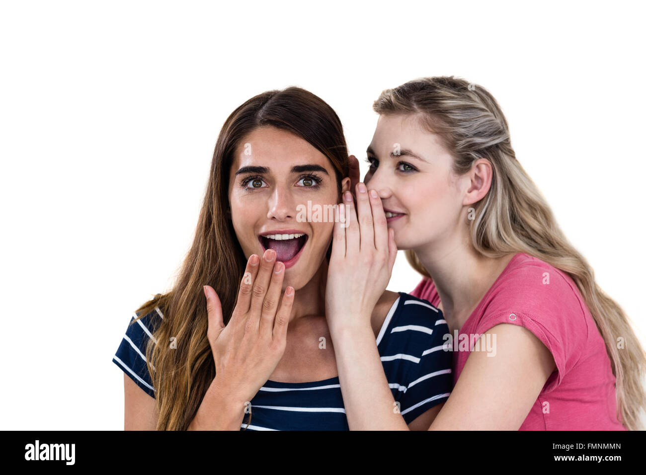 Smiling woman whispering in friend ear Stock Photo - Alamy