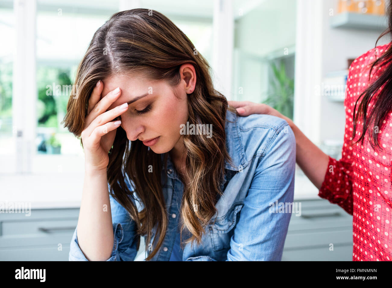 Sad young woman with friend Stock Photo - Alamy