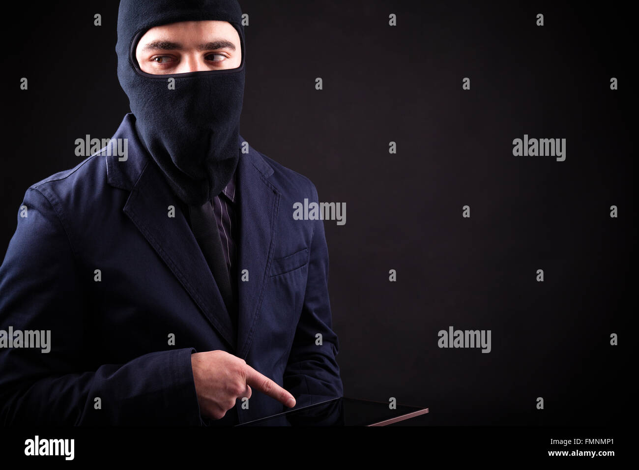 Closeup portrait of a hacker stealing data from digital tablet Stock ...