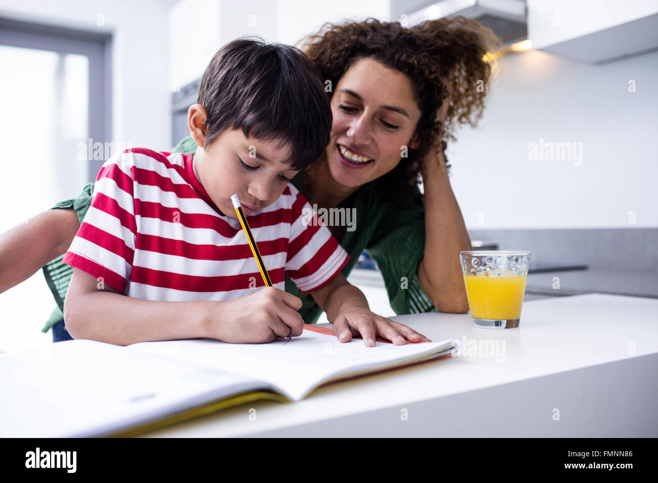 Mother helping son with homework Stock Photo - Alamy Mother helping son with homework Stock Photo - Alamy