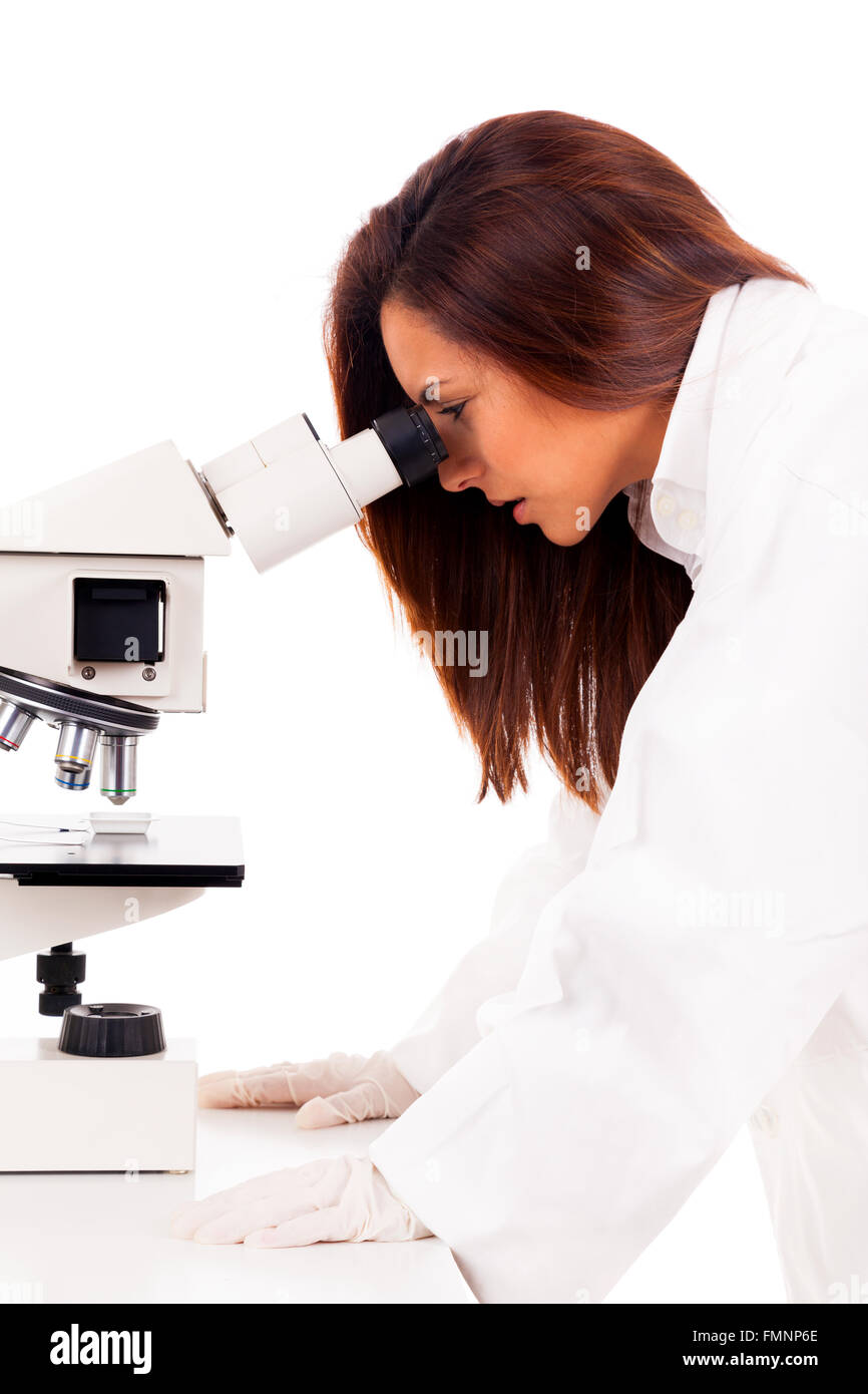 Young female researcher looking into a microscope, isolated on white ...