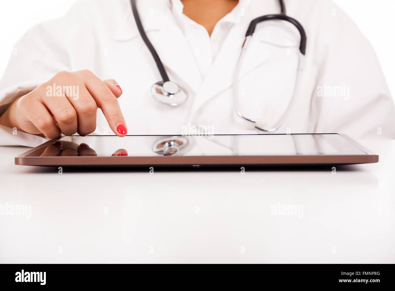 Female doctor with tablet computer at the desk, isolated over white ...