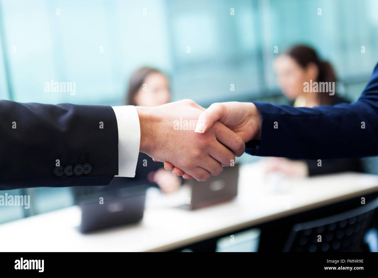 Business handshake and business people at the office Stock Photo - Alamy