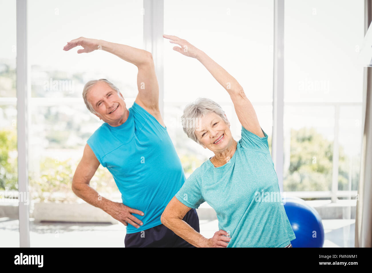 Husband and wife exercising looking at camera hi-res stock photography ...