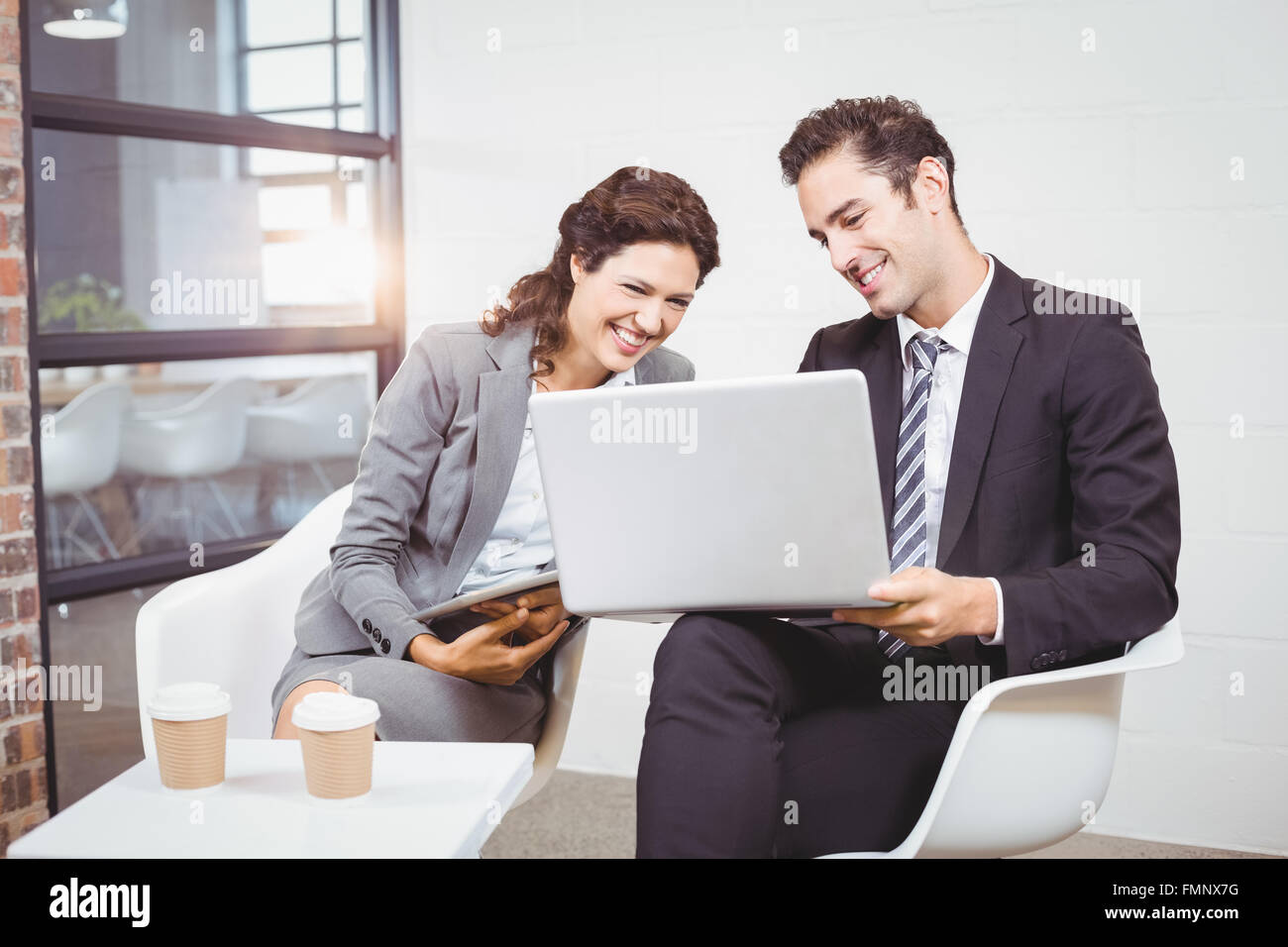 Cheerful business people using technology Stock Photo - Alamy