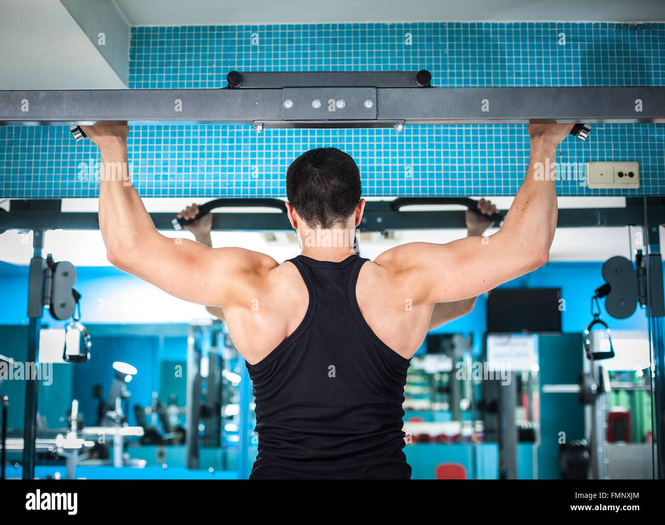 Rear view of young bodybuilder training his back Stock Photo - Alamy