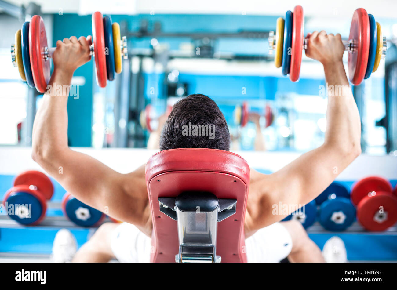 Back view of a stong man lifting weights in the gym Stock Photo - Alamy