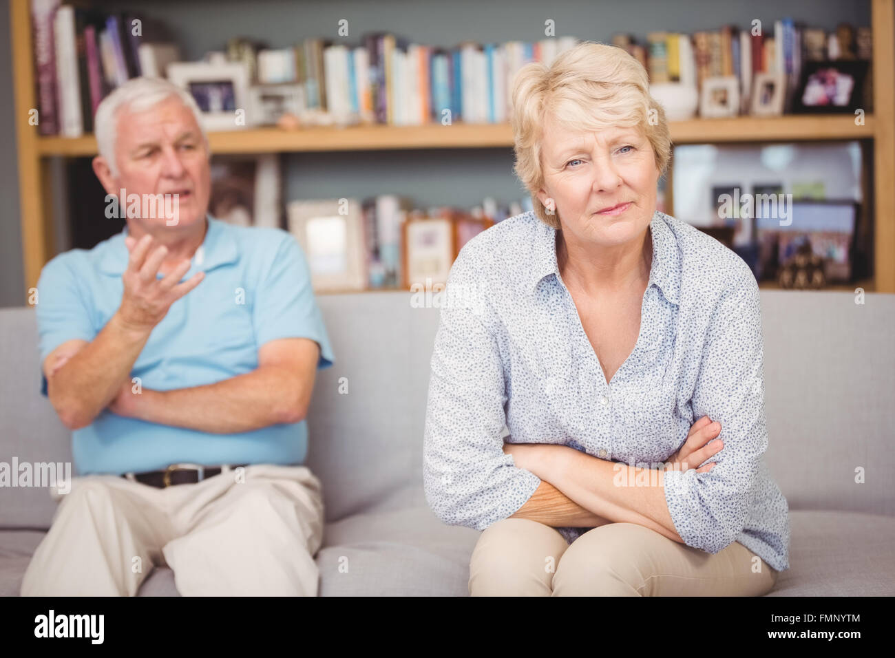 Senior couple arguing while sitting on sofa Stock Photo - Alamy