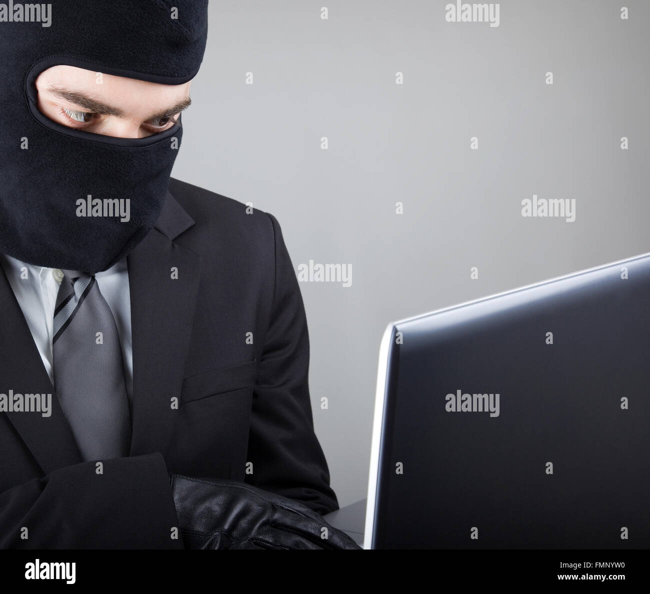 Close up of a computer hacker stealing data from laptop computer ...