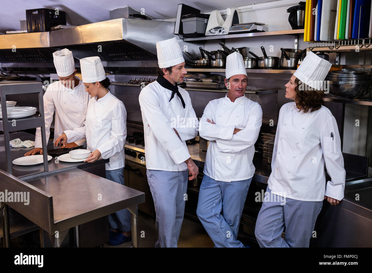 Team of chefs standing together in commercial kitchen Stock Photo - Alamy