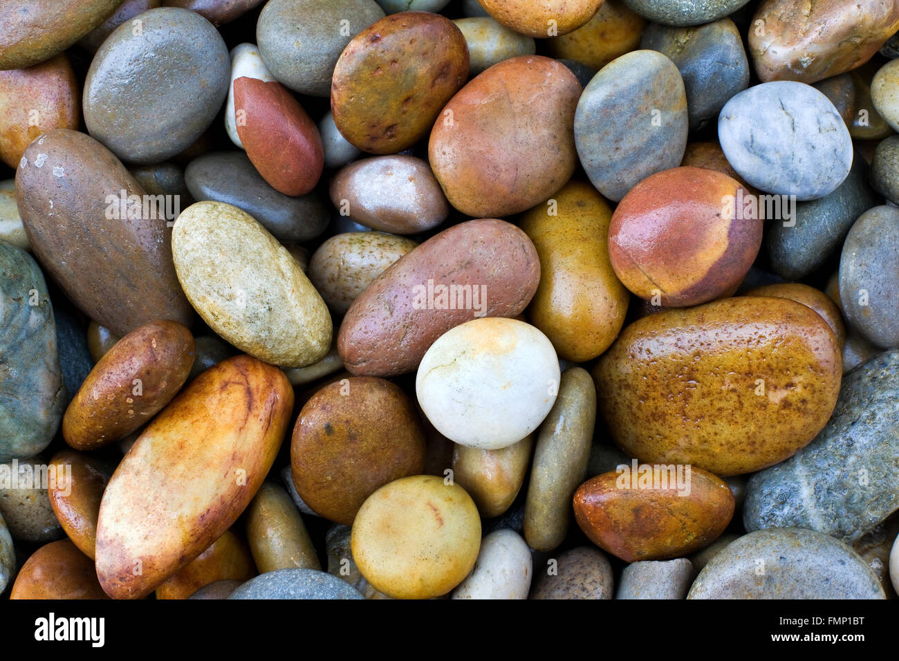 wet colored stones background Stock Photo - Alamy