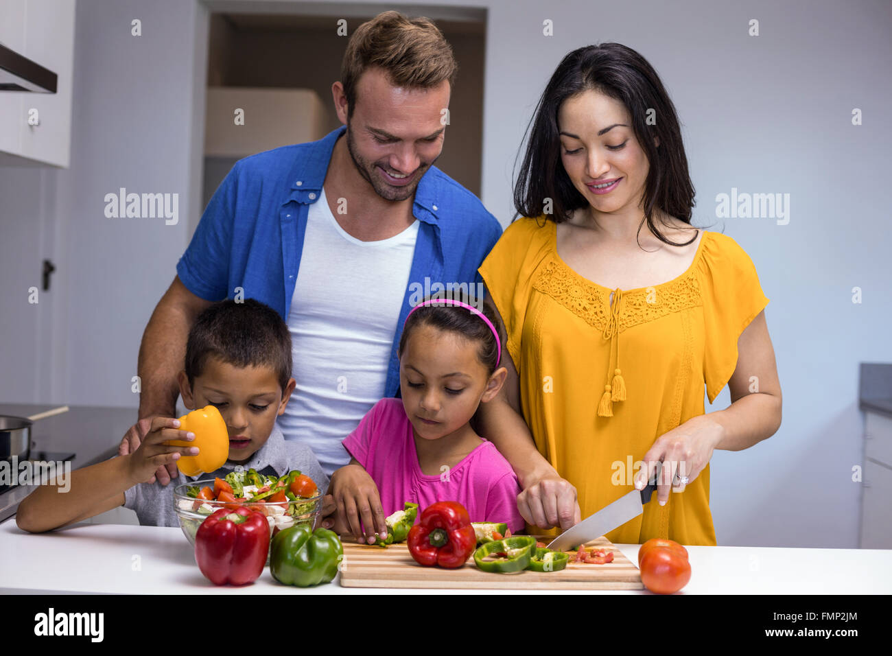 Happy family in the kitchen Stock Photo - Alamy