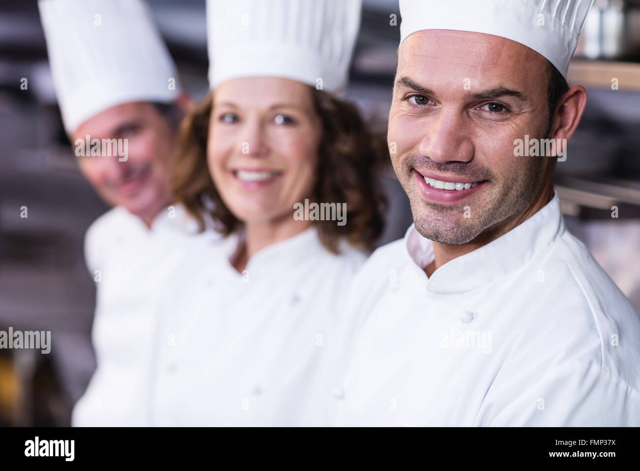 Group of happy chefs smiling at the camera Stock Photo - Alamy