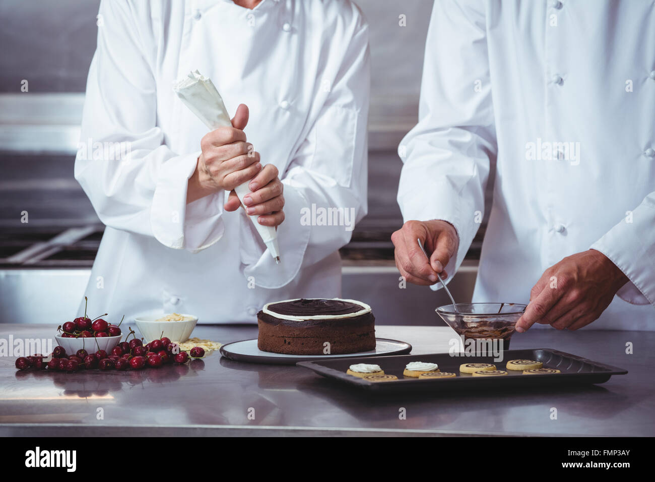 Chefs decorating a cake Stock Photo - Alamy