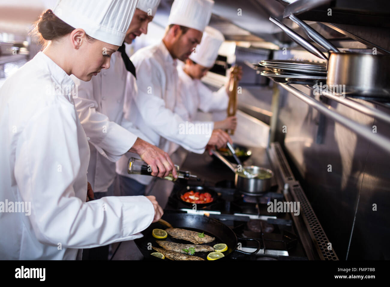 Woman frying fish hi-res stock photography and images - Alamy