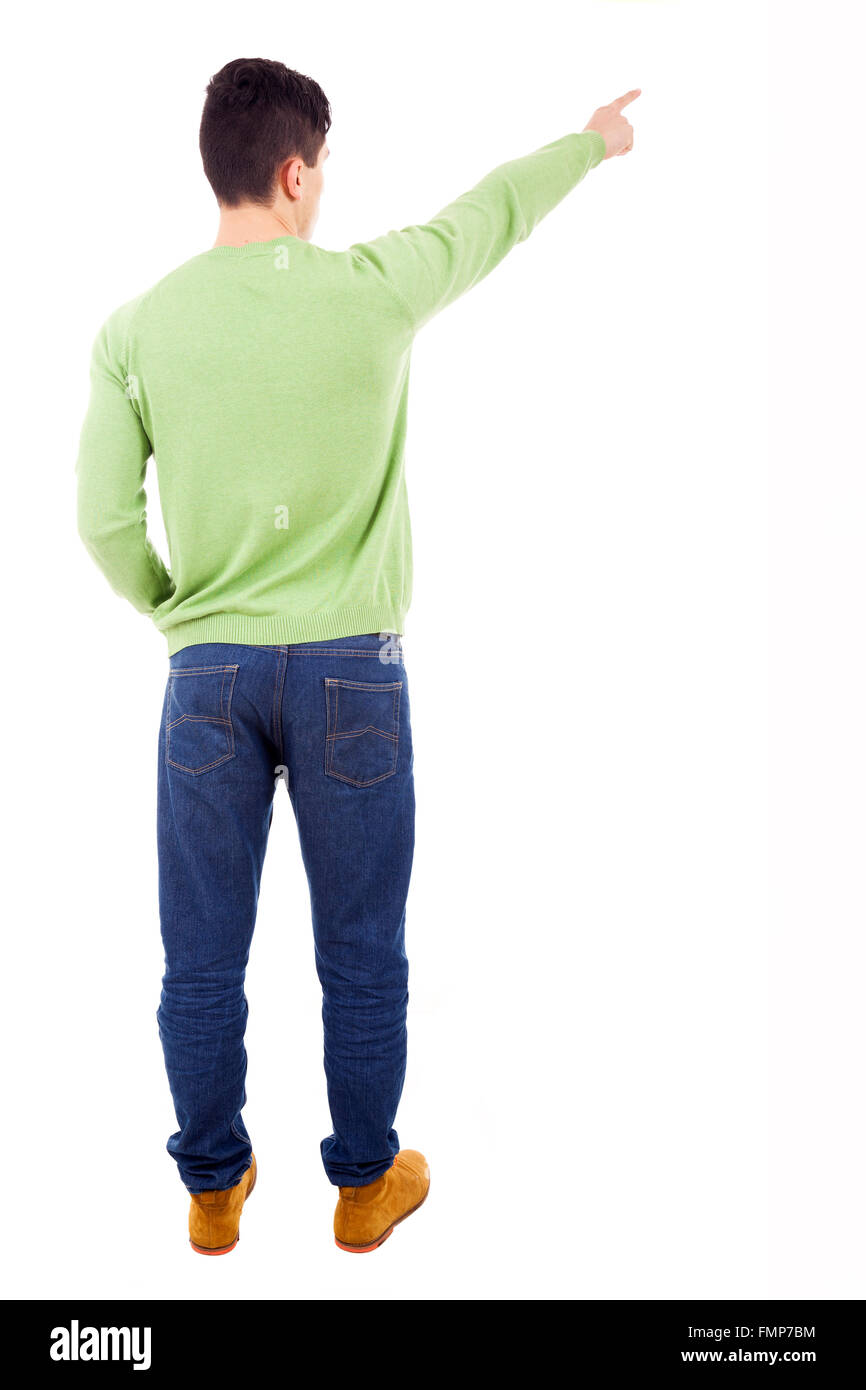Young casual man pointing at something over white background Stock ...