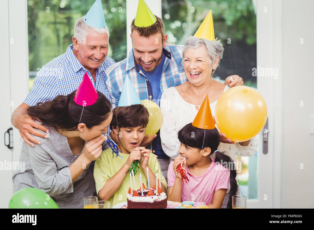 Smiling multi generation family during birthday party Stock Photo - Alamy