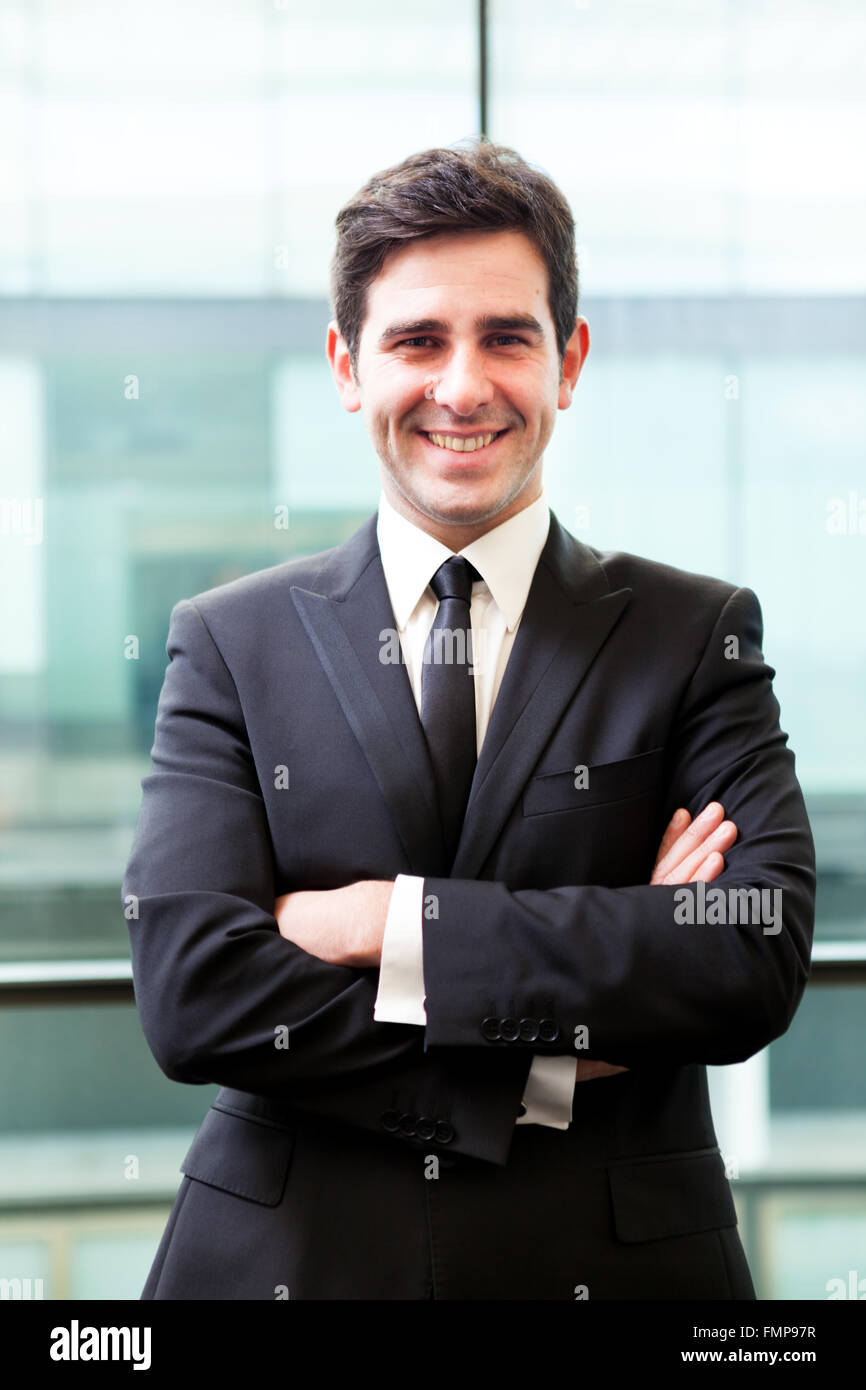 Happy smart young business man smiling at the office Stock Photo - Alamy