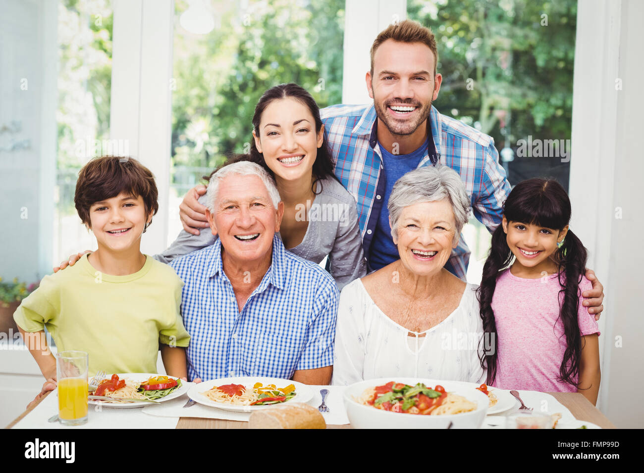 Multi generation family at dining table Stock Photo - Alamy