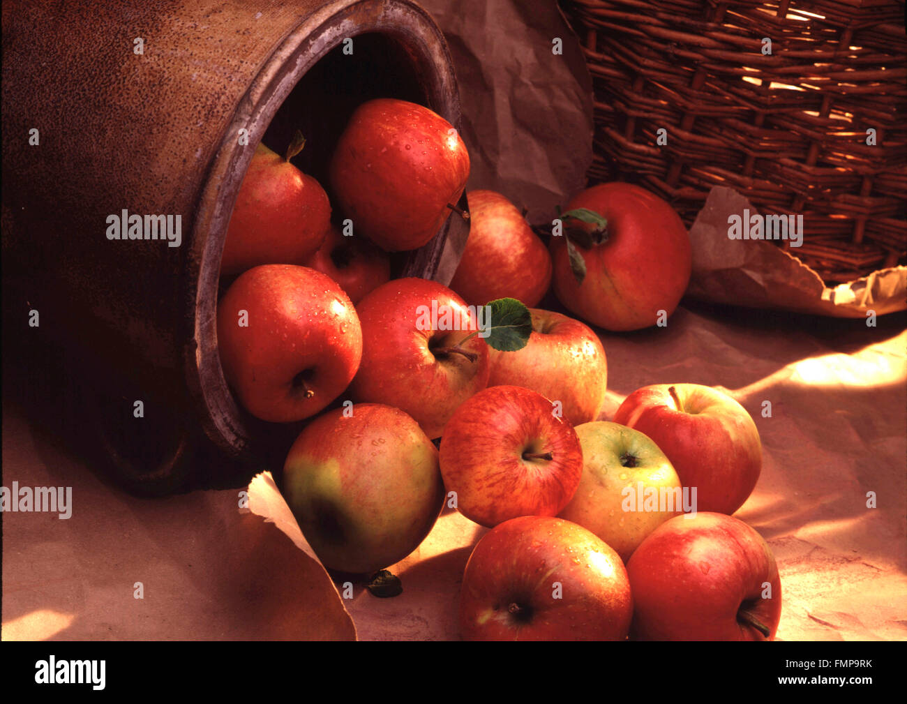 Red apples falling out of a clay pot Stock Photo - Alamy
