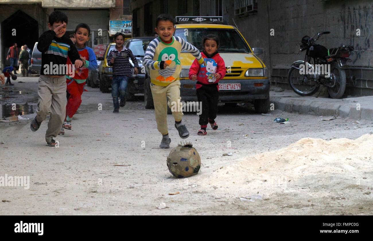 Damascus, Syria. 12th Mar, 2016. Children play soccer in the southern ...