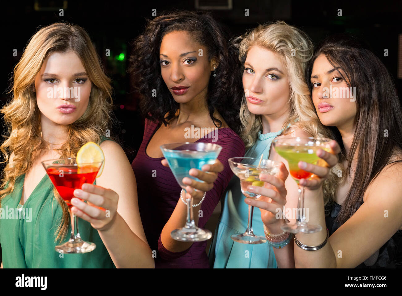 Portrait of friends having a drink Stock Photo - Alamy