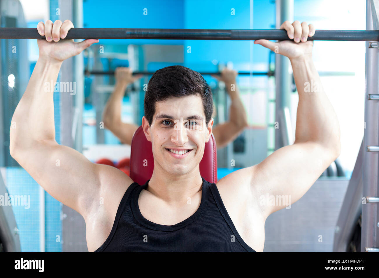 Handsome man lifting heavy weights at the gym Stock Photo - Alamy