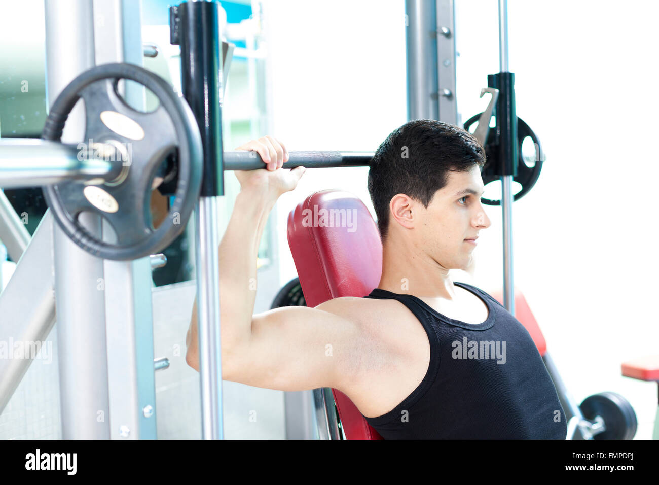 Handsome man lifting heavy weights at the gym Stock Photo - Alamy