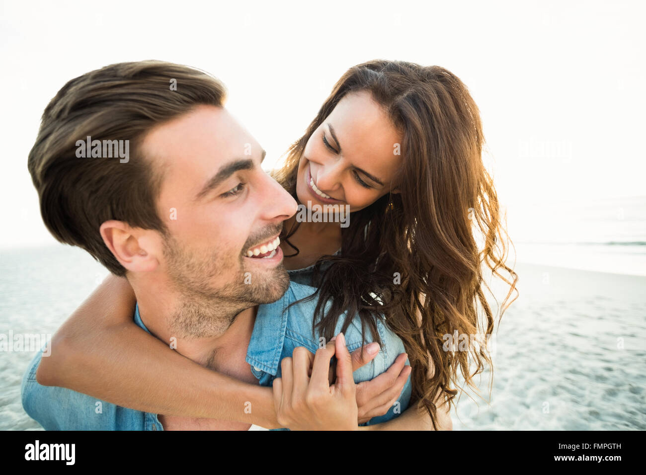 Boyfriend giving piggy back to girlfriend Stock Photo - Alamy
