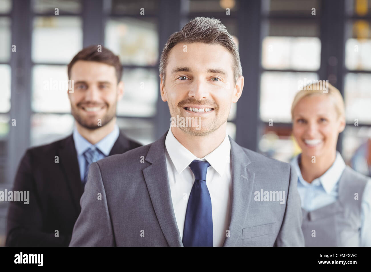 Business people wearing suit standing in office Stock Photo - Alamy