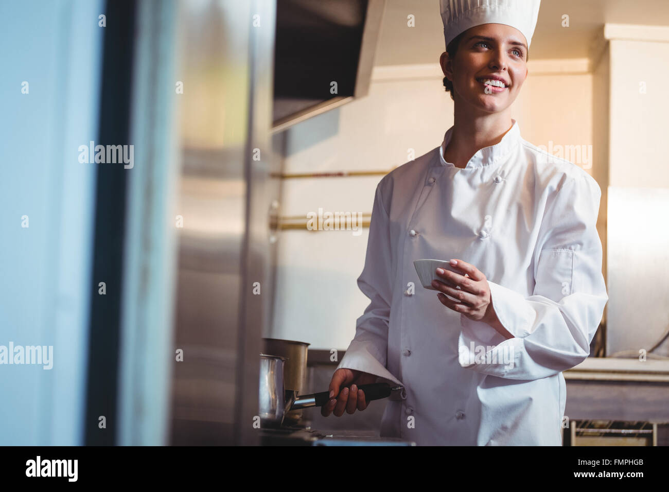 Chef adding spices in her pan Stock Photo - Alamy