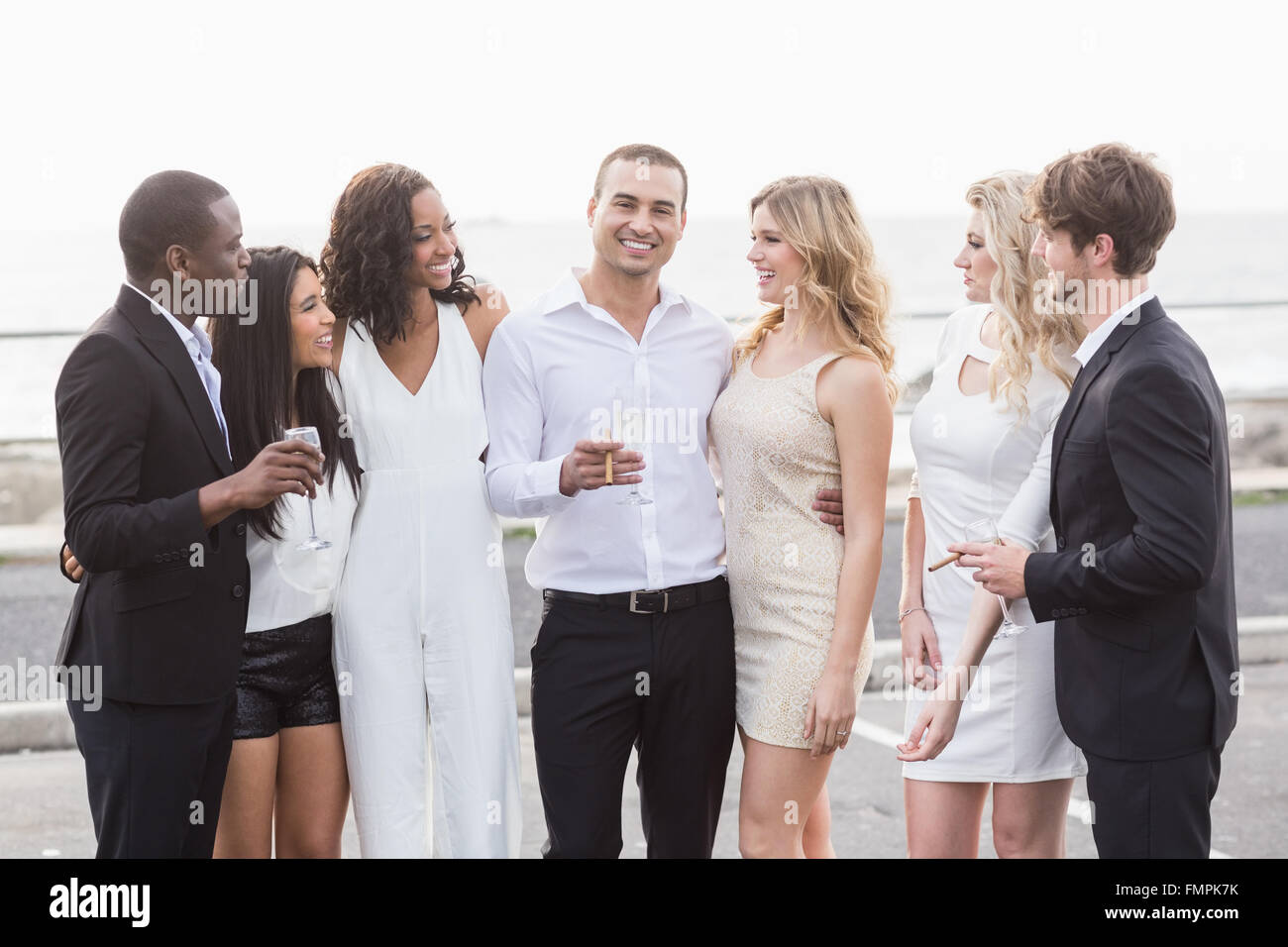 Well dressed people posing next to a limousine Stock Photo - Alamy