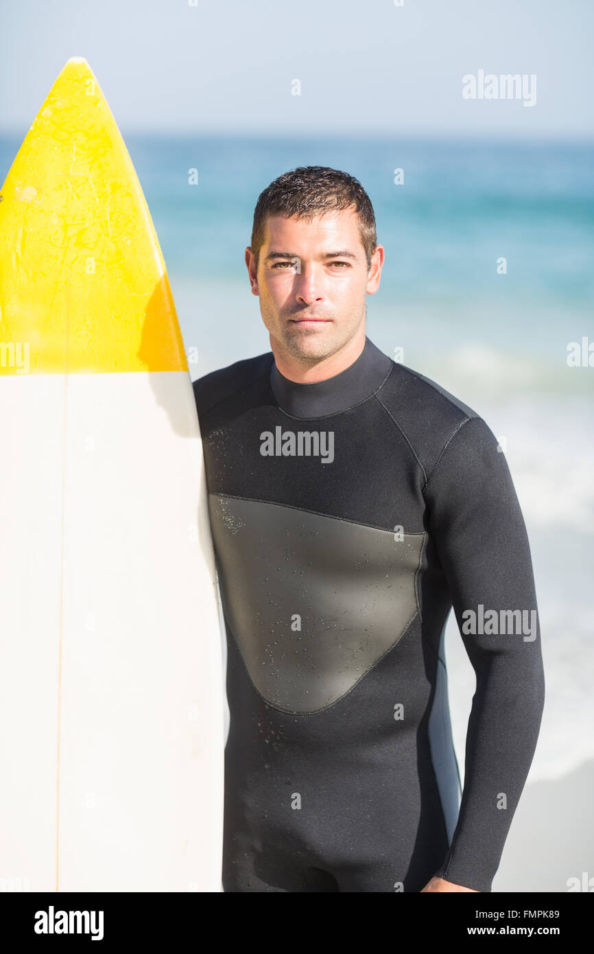 Man holding surfboard on the beach Stock Photo - Alamy