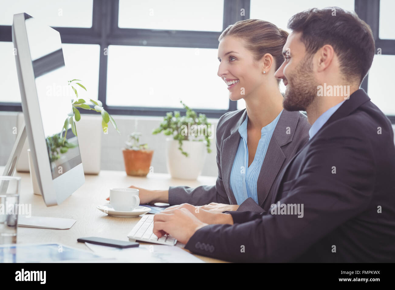 Business people working at computer desk in office Stock Photo - Alamy