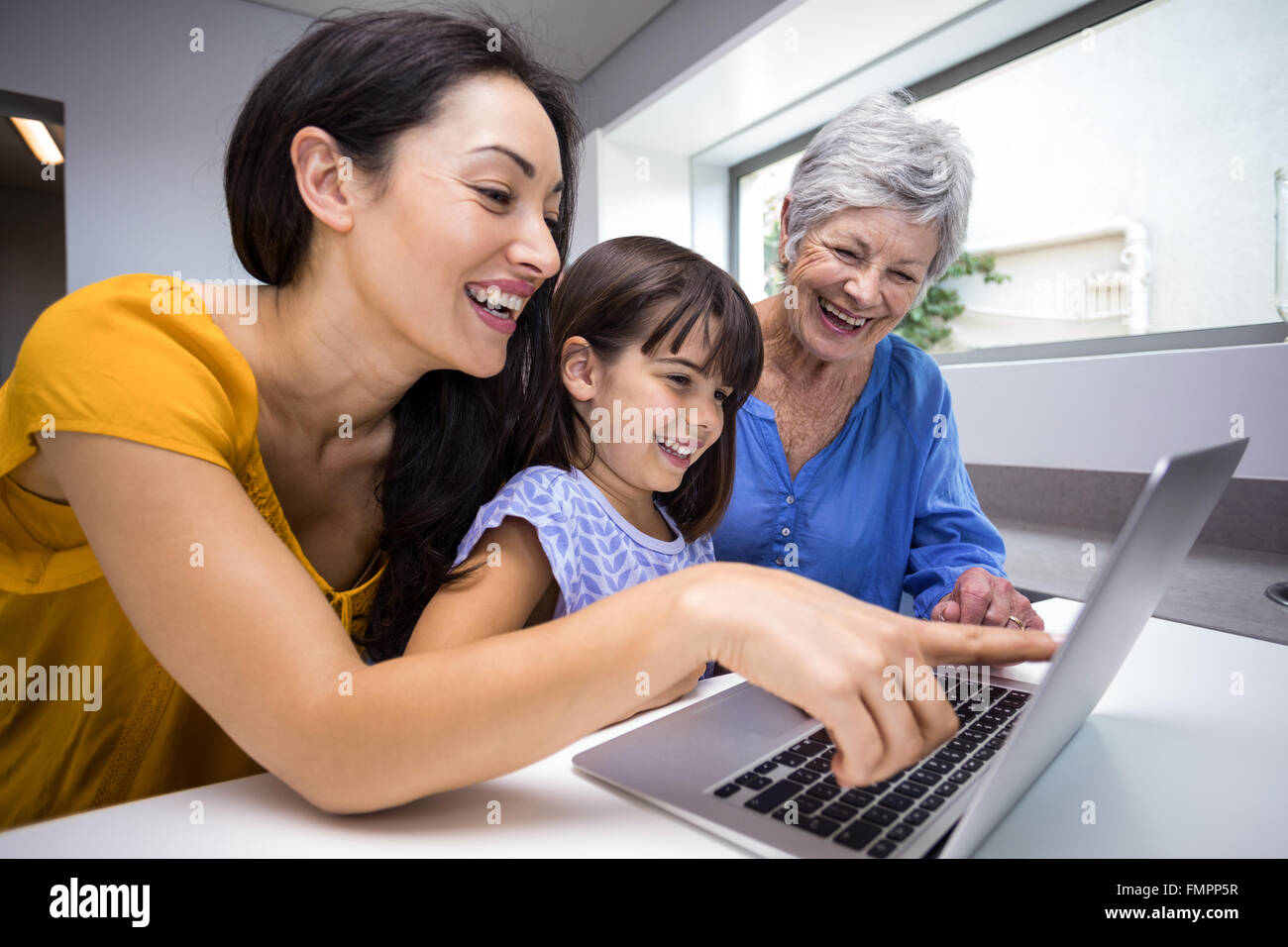Happy family interacting using laptop Stock Photo - Alamy