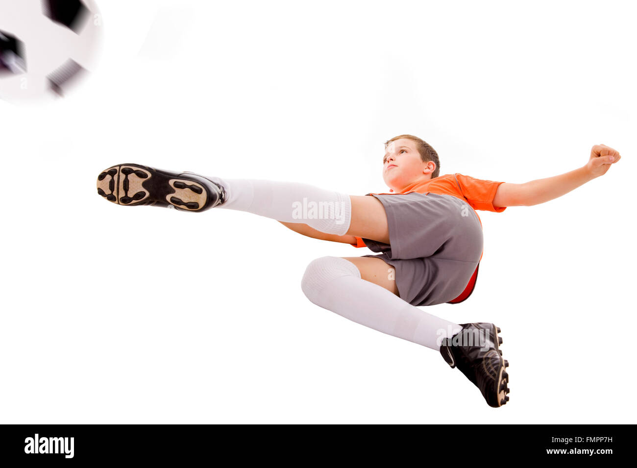 Boy kicking soccer ball, isolated on white Stock Photo - Alamy