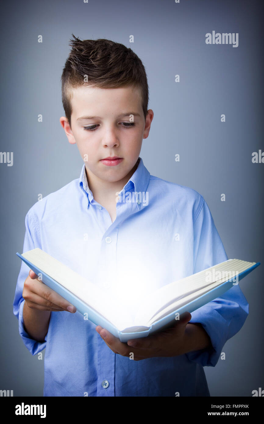 Smart child reading interesting book Stock Photo - Alamy