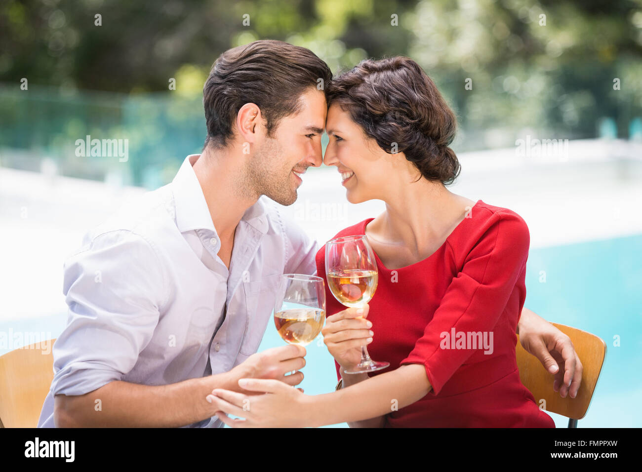 Romantic couple holding white wine Stock Photo - Alamy
