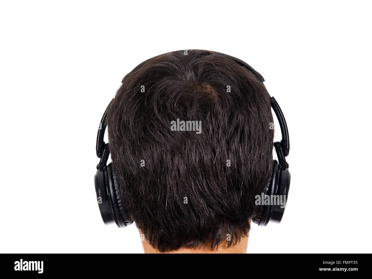 Back view of a man listening music with headphones, isolated on white ...